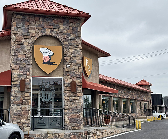 The stone fortress of flavor! Penrose Diner's distinctive exterior with its red roof and chef logo promises comfort food royalty in South Philly.
