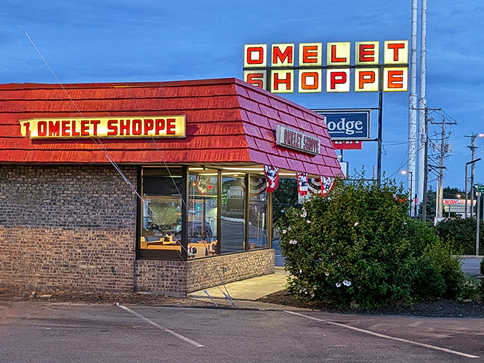 The bright red exterior of Omelet Shoppe stands out like a beacon for hungry travelers. Those patriotic bunting flags practically scream "American comfort food inside!"