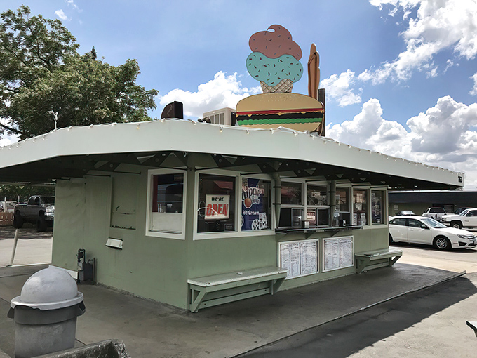That green and white beacon of burger bliss stands ready for your car-side dining adventure.