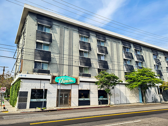 The mint-green "DINER" sign beckons like a neon lighthouse, promising refuge from Hollywood hustle in the form of perfectly cooked eggs and bottomless coffee.