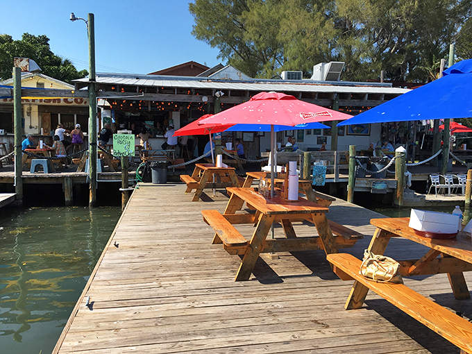Waterfront dining where fishing boats and picnic tables create the perfect symphony of Old Florida charm.