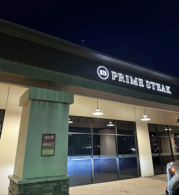 By night, the illuminated sign beckons meat lovers like a carnivorous lighthouse guiding hungry sailors to beefy shores.