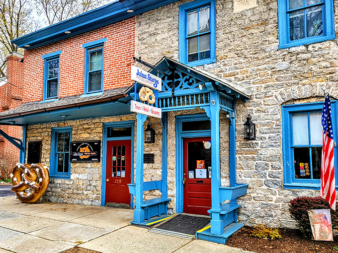 The stone and brick exterior of Julius Sturgis stands like a time capsule of pretzel history, complete with that iconic blue trim that practically winks at you from the street.