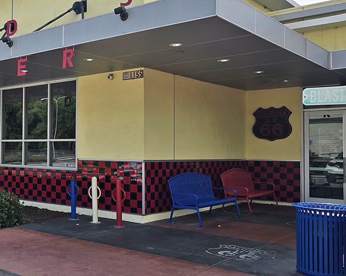 The classic exterior of Legends beckons with its vibrant landscaping and inviting red umbrellas—a time capsule of Americana waiting in Glendora.