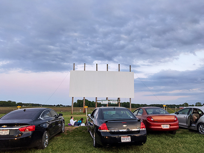 Cars lined up facing the towering white screen, where cinematic magic awaits under a moody Ohio sky. The perfect backdrop for memory-making.