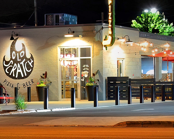 By night, Old Scratch transforms into a warm beacon for pizza pilgrims, its string lights and glowing interior promising comfort and community in equal measure.