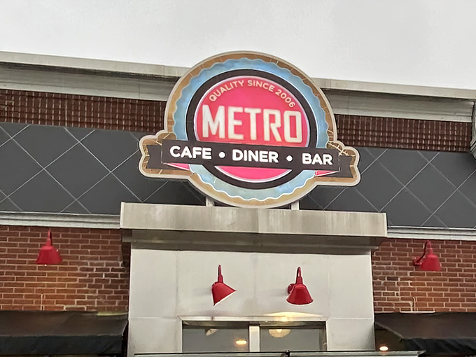 The bright Metro Cafe Diner sign beckons like a lighthouse for the hungry, promising refuge from sad homemade sandwiches and disappointing drive-thru fare.