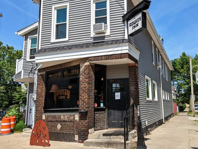 The corner entrance to The Rowley Inn beckons like an old friend, its vintage sign promising comfort and camaraderie in Cleveland's historic Tremont neighborhood.