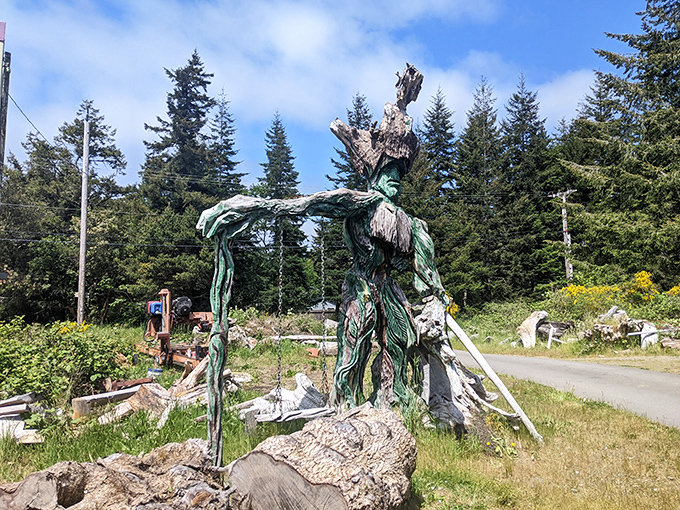 A green sentinel rises from the forest floor, arms outstretched as if to welcome wanderers into this woodland realm of imagination.