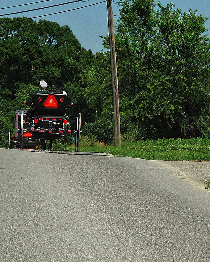 Where worlds collide: An Amish buggy shares the road with modern cars at the entrance to Strasburg Rail Road, a perfect metaphor for this time-traveling town.