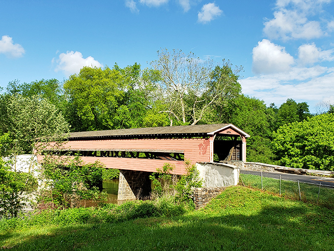 The rustic red exterior of Smith's Bridge stands proudly against Delaware's lush greenery, like a postcard from America's simpler past.