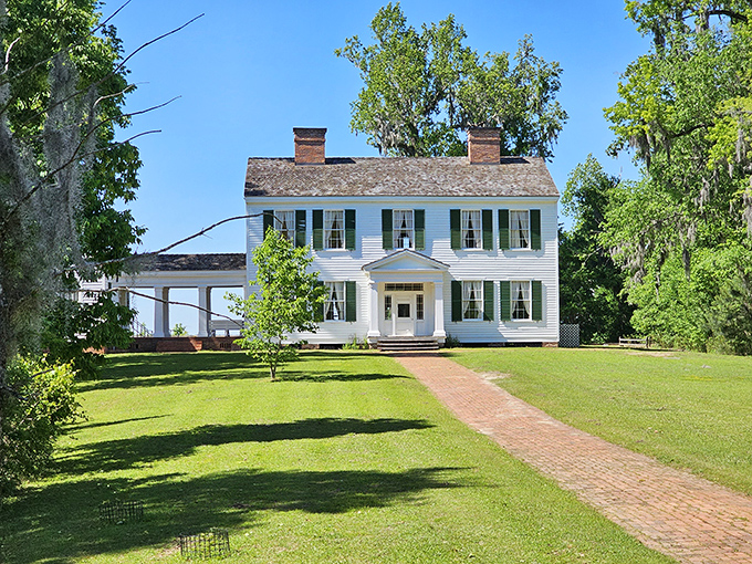 The Gregory House stands like a Southern belle against the Florida sky, a pristine antebellum mansion that somehow wandered north from Gone with the Wind territory.