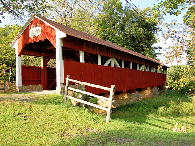 The classic red exterior of Trostletown Covered Bridge stands as a vibrant reminder of Pennsylvania's rich architectural heritage, beckoning travelers to step back in time.