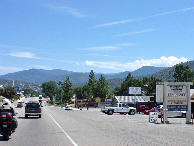 Main Street Oakhurst stretches toward pine-covered mountains like nature's welcome mat. Small-town charm with big mountain views.