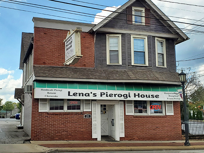 The sign says it all! Lena's Pierogi House welcomes hungry visitors with its whimsical dancing dumplings, promising Eastern European comfort in Hubbard's heart.