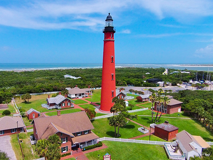 Standing tall like a crimson exclamation point on Florida's coastline, this 175-foot giant has been photobombing beach selfies since the 1880s.