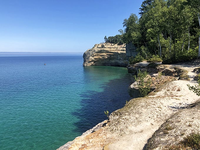 Lake Superior's turquoise waters meet towering sandstone cliffs, creating a Caribbean mirage in Michigan's Upper Peninsula. Mother Nature showing off again!