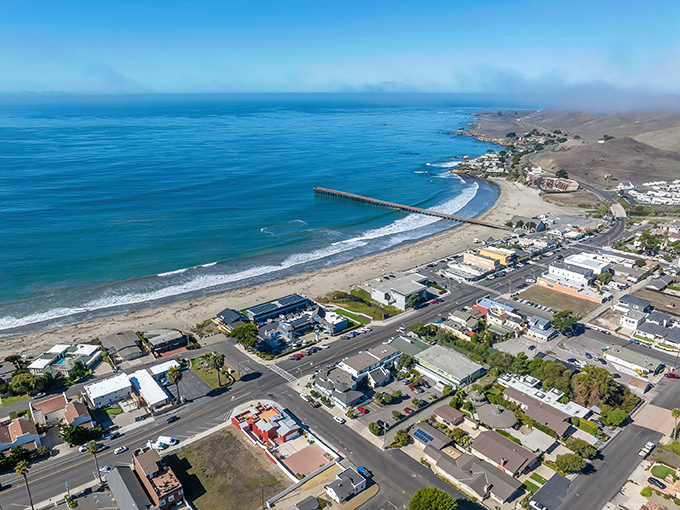 Cayucos stretches along the coastline like a postcard come to life, with its iconic pier reaching into the Pacific like nature's welcome mat.