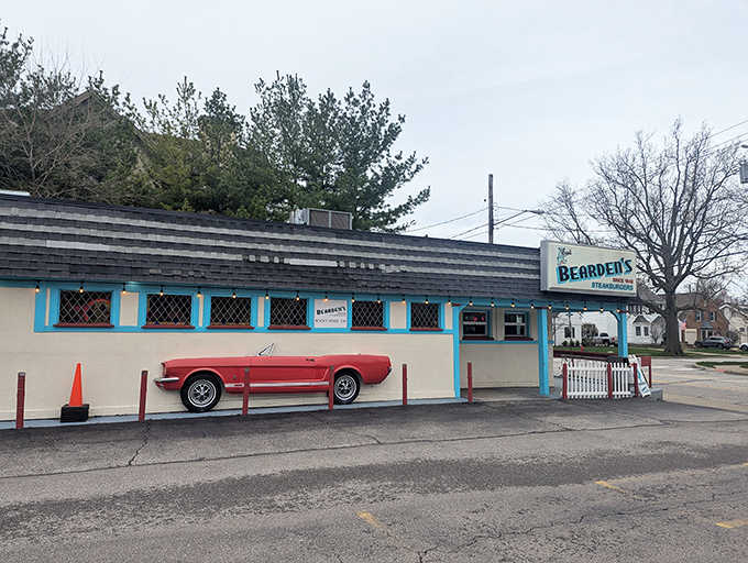 That classic turquoise and cream exterior isn't just eye-catching&mdash;it's a time portal to when burgers were simple and perfect. The vintage Mustang completes the postcard.