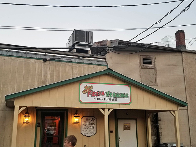 The unassuming yellow exterior of Fiesta Veracruz might not scream "culinary destination," but those colorful flower pots are your first clue to the flavor explosion waiting inside.