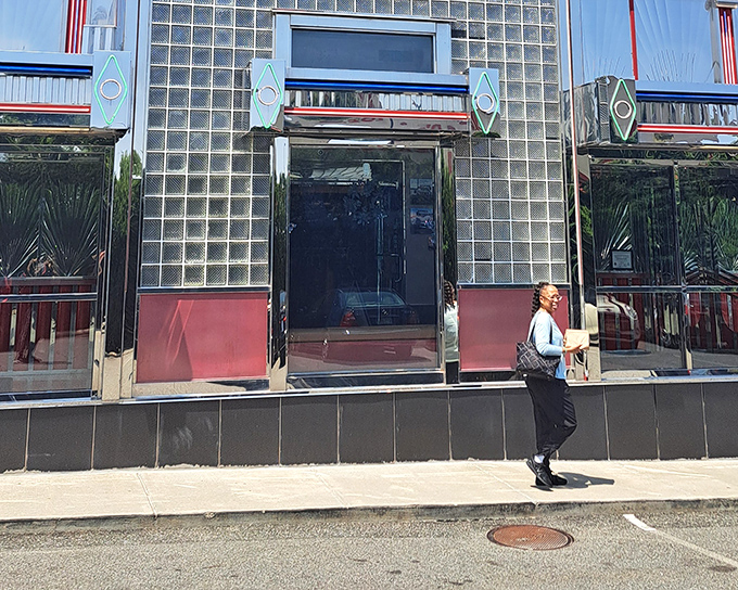 The gleaming art deco fa&ccedil;ade of Tick Tock Diner stands as a chrome-plated time machine on Route 3, beckoning hungry travelers with its unmistakable retro charm.