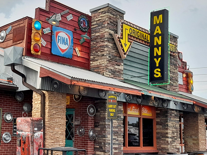 The neon sign at Manny's Original Chophouse glows like a beacon for hungry travelers, promising carnivorous delights behind that stone and brick facade.