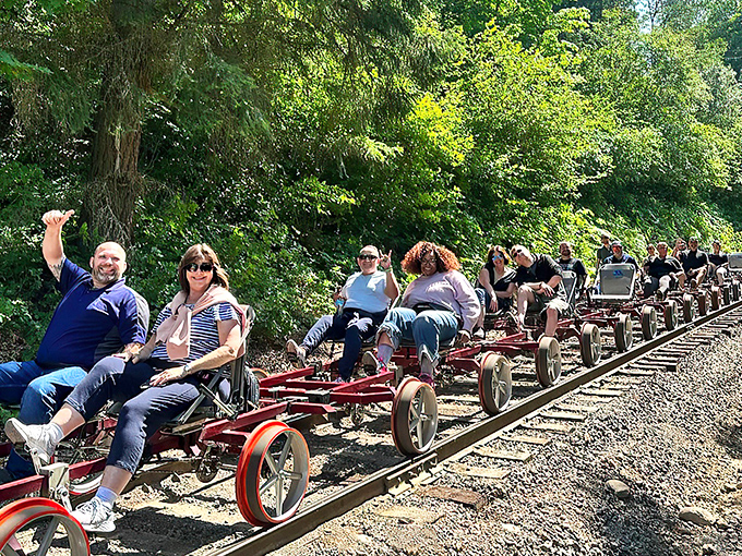 All aboard the fun express! Rail bikers wave with the unbridled joy that only comes from pedaling where trains once ruled, surrounded by Oregon's lush greenery.