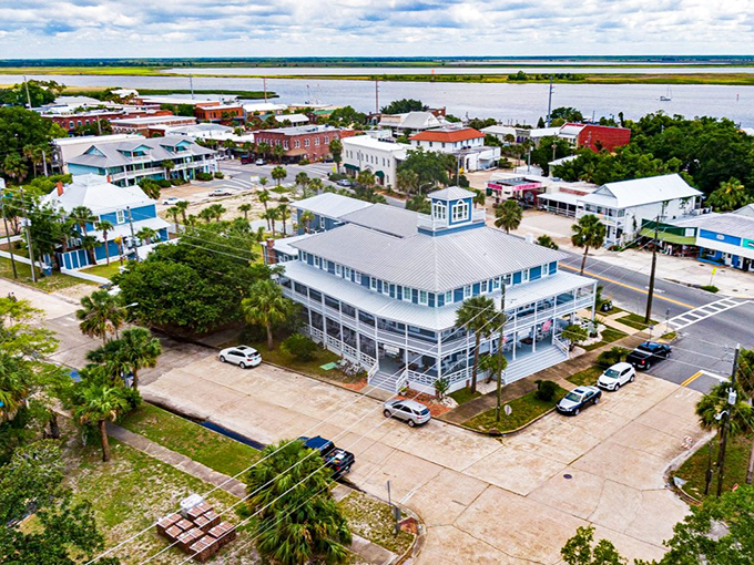 Apalachicola's historic district unfolds like a watercolor painting, where Victorian architecture meets coastal charm in this aerial view of Florida's forgotten treasure.