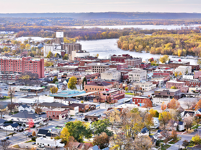 Red Wing unfolds along the Mississippi River, where historic brick buildings meet autumn-painted bluffs in perfect harmony.