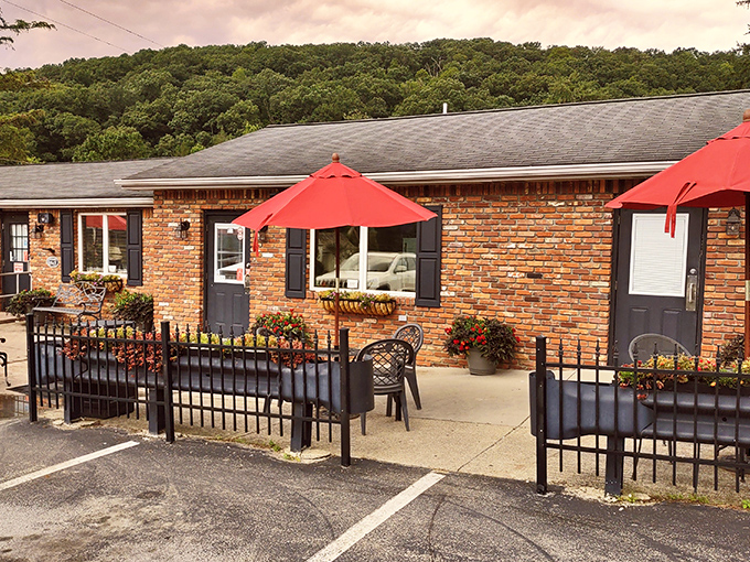 Red umbrellas and wrought iron fencing create a charming outdoor space where the only thing better than the Laurel Highlands view is what's waiting inside.