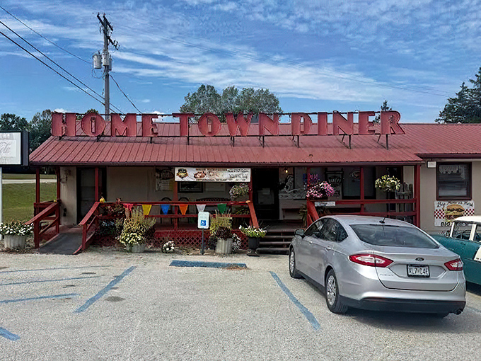 The iconic red roof and bold lettering of Home Town Diner stands as a beacon of comfort food in Hermitage, where colorful flower pots welcome hungry travelers.