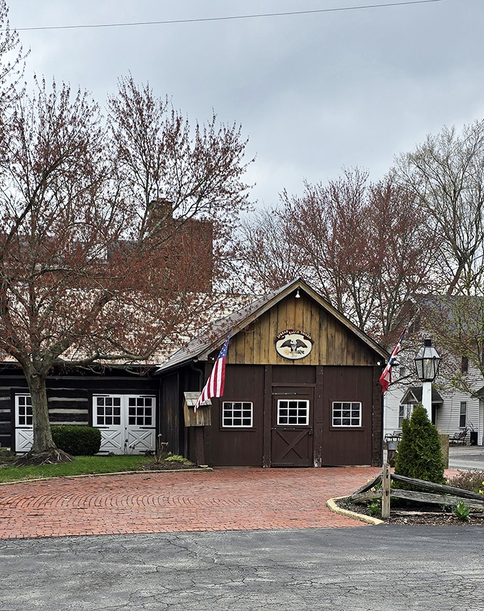The historic facade of Spread Eagle Tavern welcomes visitors with rustic charm, a brick courtyard, and the promise of culinary time travel in rural Hanoverton.