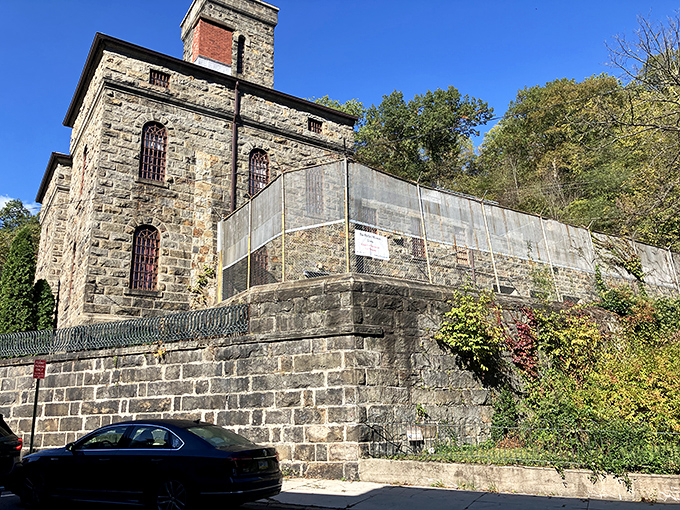 The imposing stone fortress of the Old Jail Museum stands against a blue sky, looking more like a medieval castle than a place for time-outs.