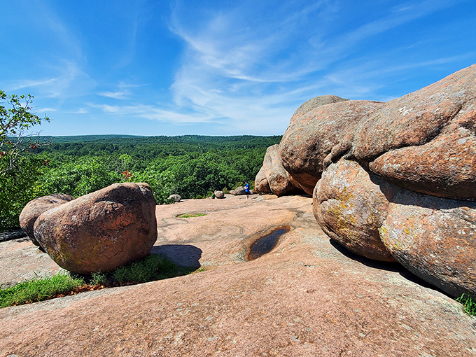 Nature's own sculpture garden: massive pink granite boulders stand sentinel against a brilliant blue Missouri sky, inviting explorers of all ages.