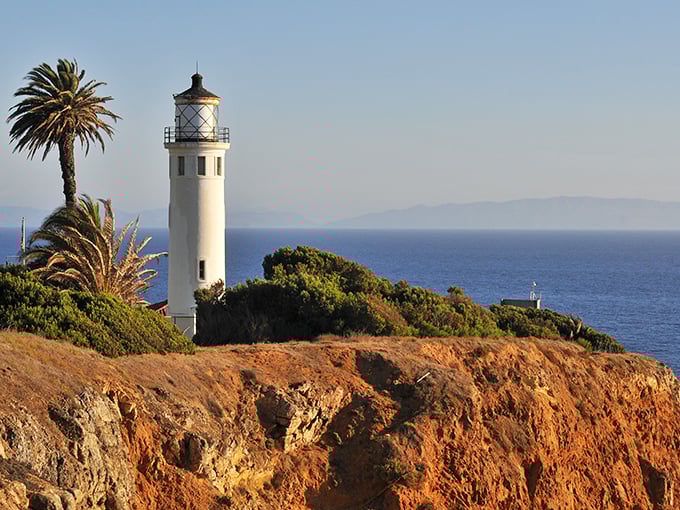 California's answer to Maine lighthouses stands tall against the Pacific blue, palm trees adding that quintessential West Coast flair.