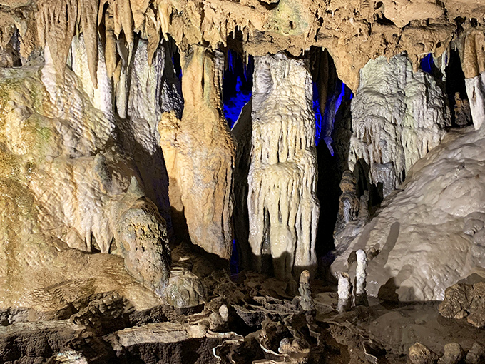 The dramatic blue lighting transforms ordinary rock formations into something magical, like Mother Nature's own light show beneath the Florida Panhandle.