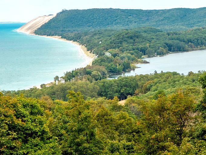 Nature's perfect sandwich: South Bar Lake nestled between lush forests and Lake Michigan's vast blue horizon. Michigan's geography showing off like it's auditioning for National Geographic.