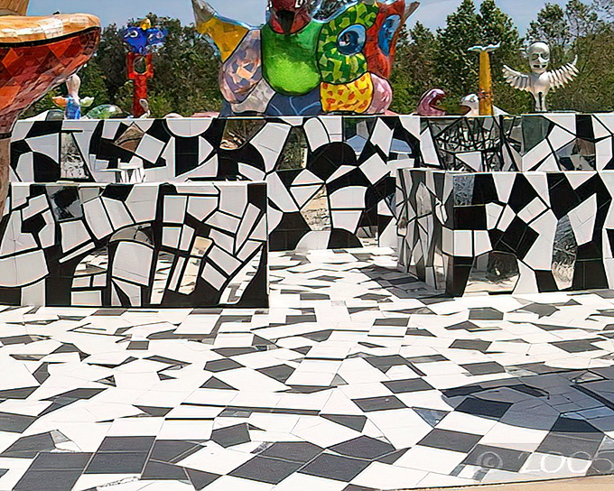 The black-and-white mosaic maze leads visitors into a psychedelic dreamscape where colorful totemic creatures stand guard like sentinels from another dimension.