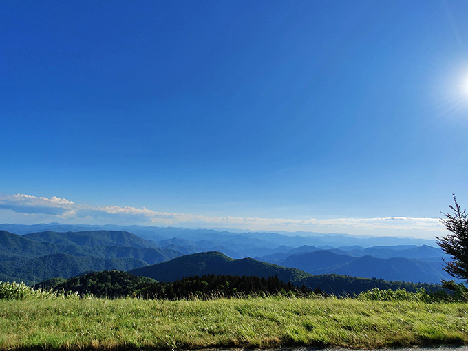 From Cowee Mountain Overlook, the view rolls out in endless blue layers beneath a flawless Carolina sky.