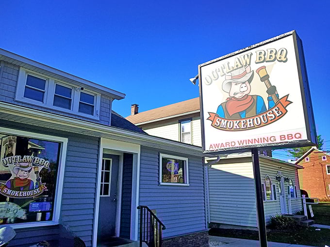 The blue clapboard exterior of Outlaw BBQ might look unassuming, but that cartoon pig with a shotgun isn't kidding around about serious flavor.