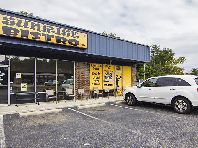 No fancy frills here&mdash;just that iconic blue-and-yellow Sunrise Bistro sign announcing you've arrived at breakfast paradise. The neon "OPEN" sign might as well say "Enter and be happy."