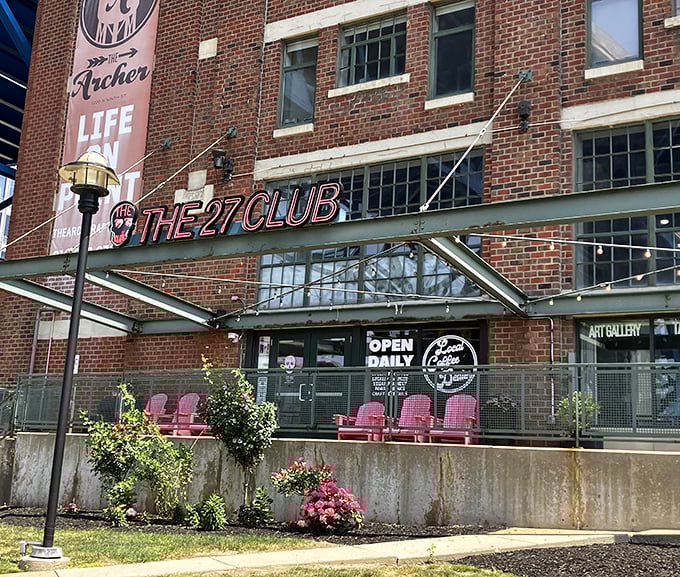 The 27 Club's striking brick exterior and neon signage stands as a love letter to rock history, while pink chairs promise comfort for the living.