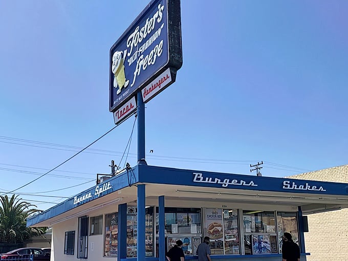 The iconic blue and white Fosters Freeze sign stands tall against the California sky, a beacon of nostalgia promising "Burgers, Shakes" and frozen happiness.