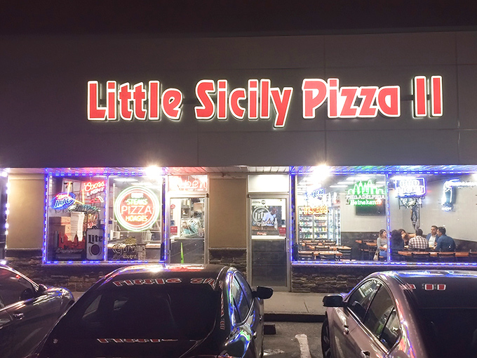 Little Sicily Pizza II glows like a beacon in the night, promising comfort food salvation for hungry Philadelphians seeking their cheesesteak fix.