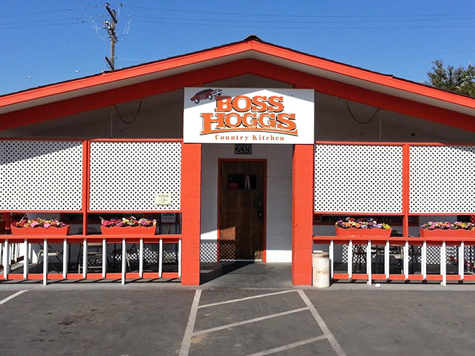 The bright orange facade of Boss Hogg's stands like a beacon of comfort food hope in Farmersville, promising Southern hospitality with California sunshine.