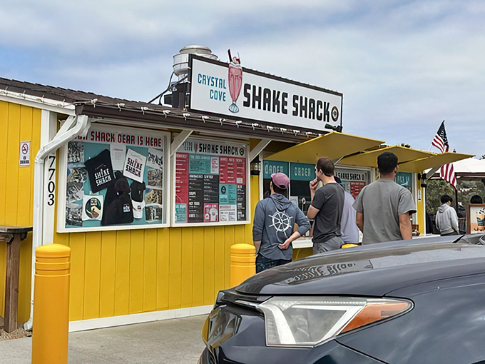 The sunshine-yellow facade of Crystal Cove Shake Shack stands like a beacon of hope for hungry travelers along PCH, promising milkshake salvation and burger bliss.