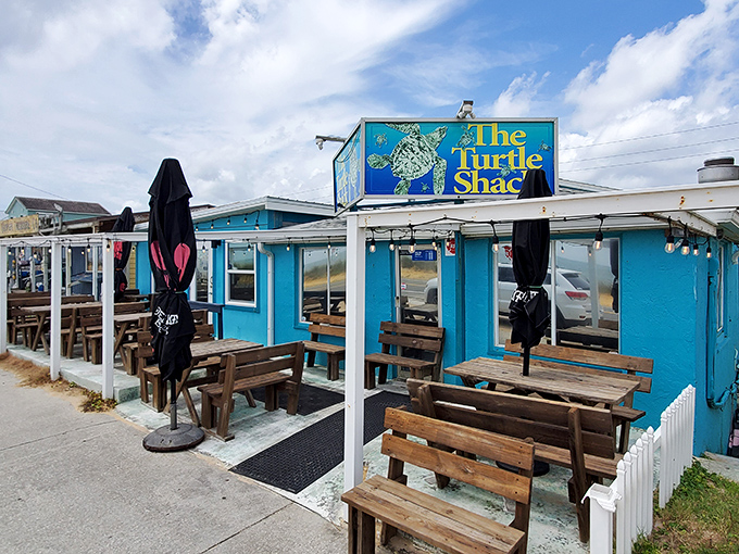 The vibrant turquoise exterior of Turtle Shack stands out like a cheerful beacon along Palm Coast's A1A, promising seafood treasures within those humble walls.