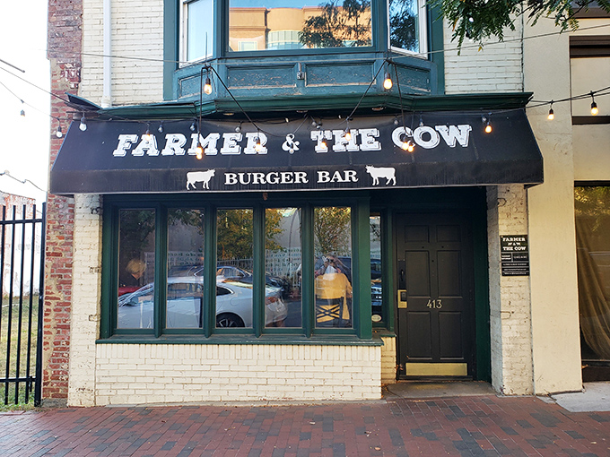 The unassuming storefront of Farmer & The Cow beckons with its classic black awning and white lettering—proof that culinary treasures often hide in plain sight.