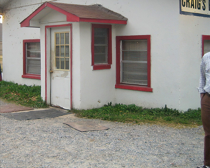 The humble white exterior with classic Coca-Cola signage proves once again that the best BBQ joints never waste money on fancy architecture.