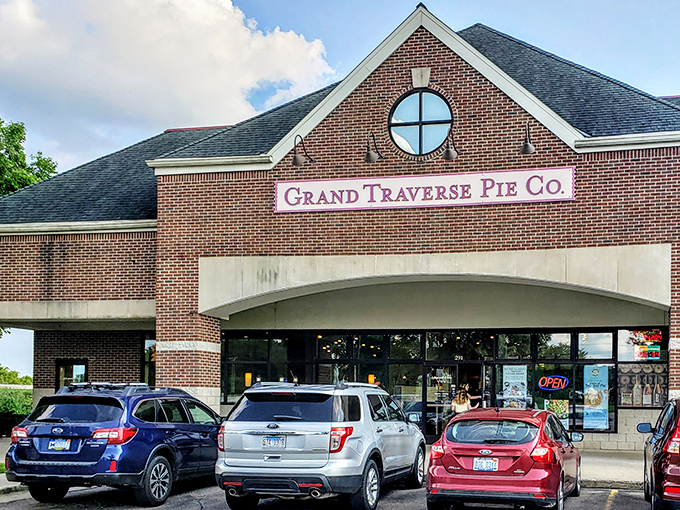 The brick facade of pie paradise beckons like a lighthouse to dessert-seeking souls. That circular window? A portal to pastry heaven.